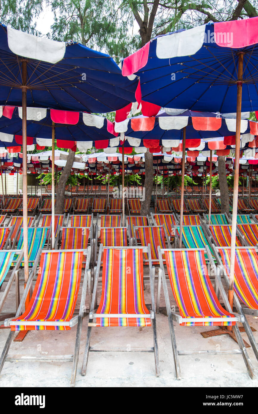 Lines of colorful beach chairs on sandy beach in Thailand Stock Photo ...