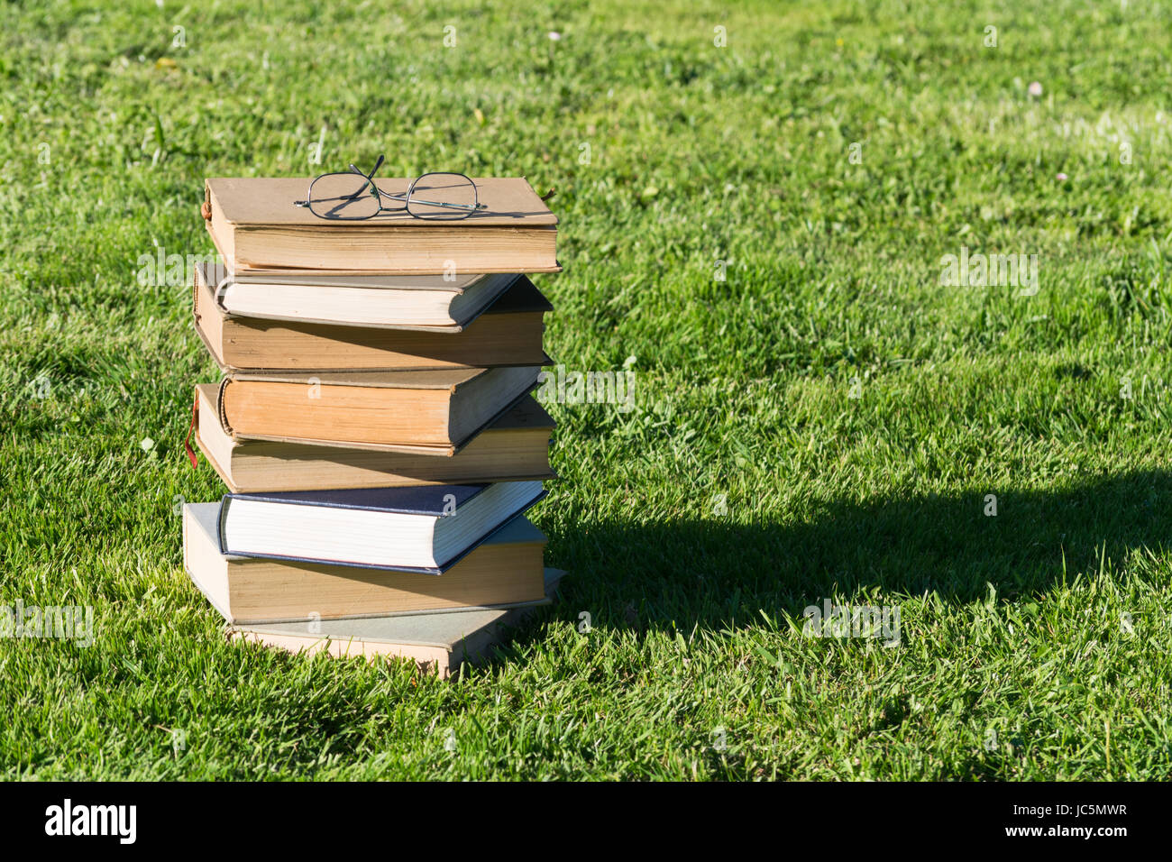 book on the grass Stock Photo - Alamy