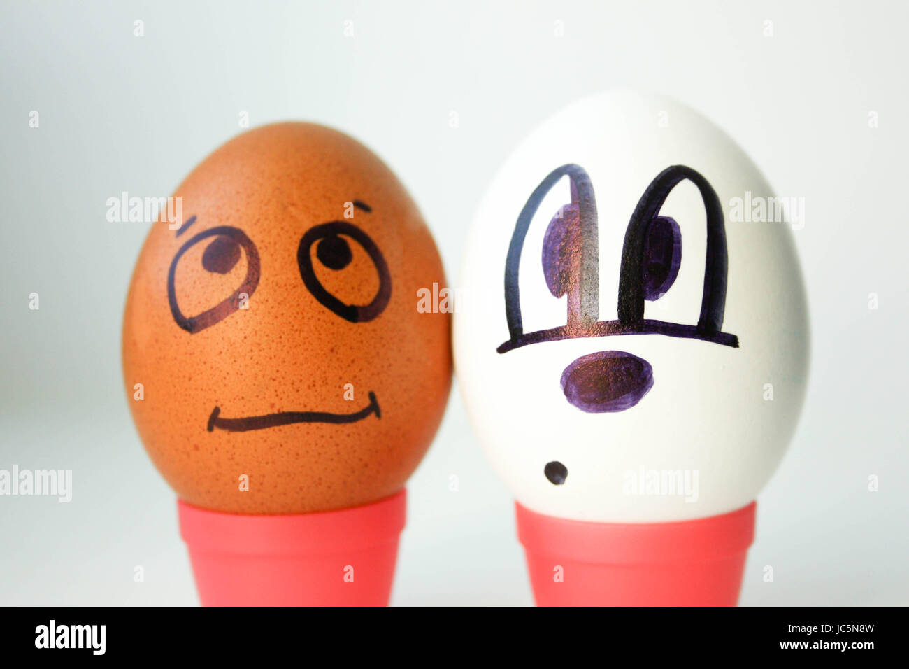 The concept of racism. White and black. Eggs with painted face. on a ...