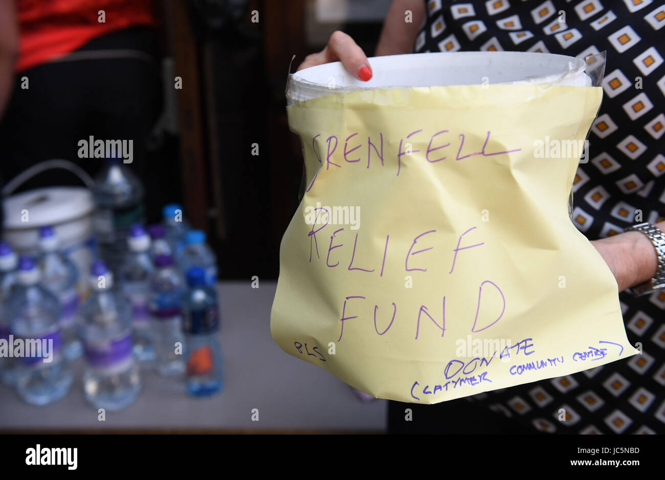 A relief fund bucket set up by local residents for those caught up in a ...