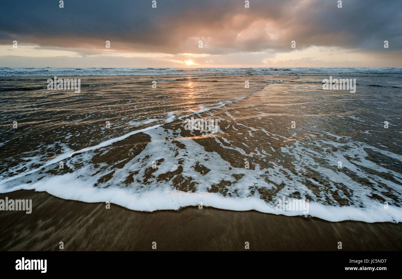 Waves flowing across the shallow sands of Pembrey Beach (Cefn Sidan ...