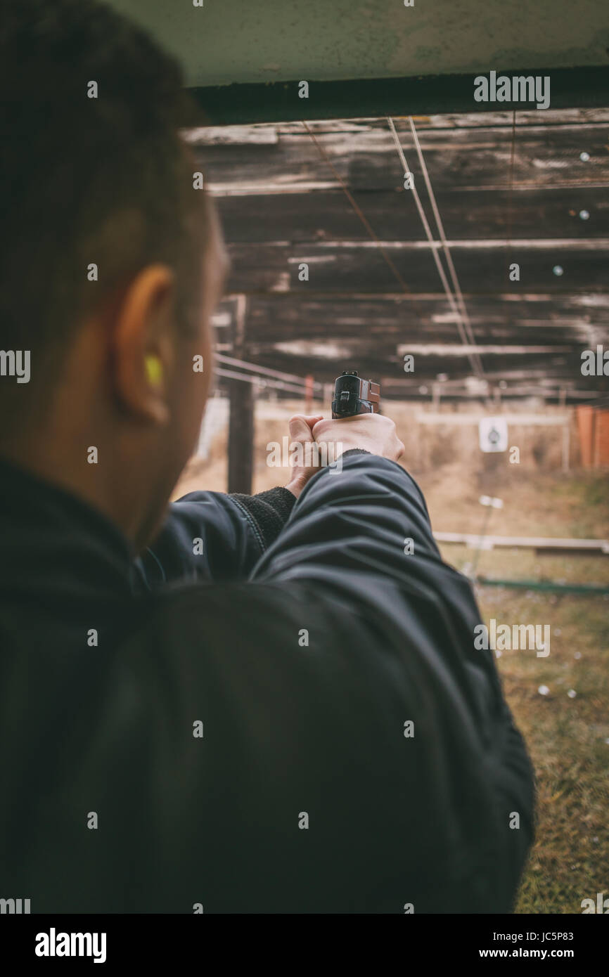 Man firing with pistol on target at the shooting range. Close-up Stock ...