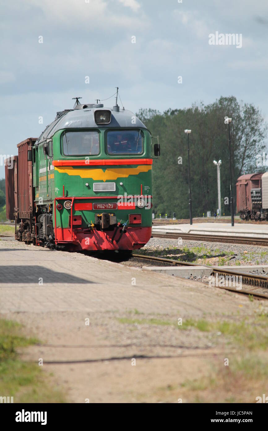 green retro style train with yellow line stay on way still working ...