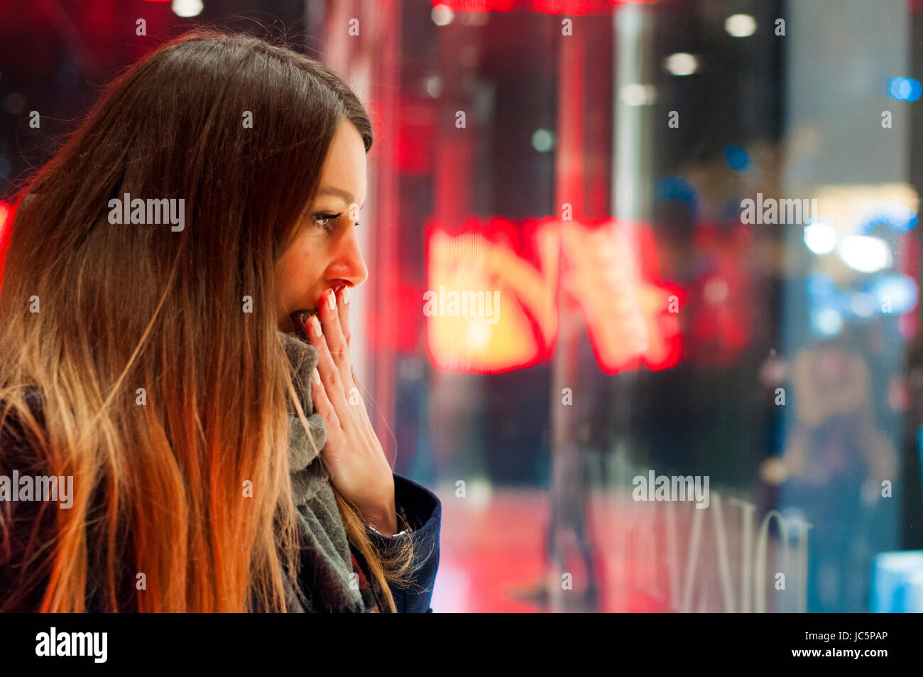 Window shopping, woman looking at the store. Smiling woman pointing at ...