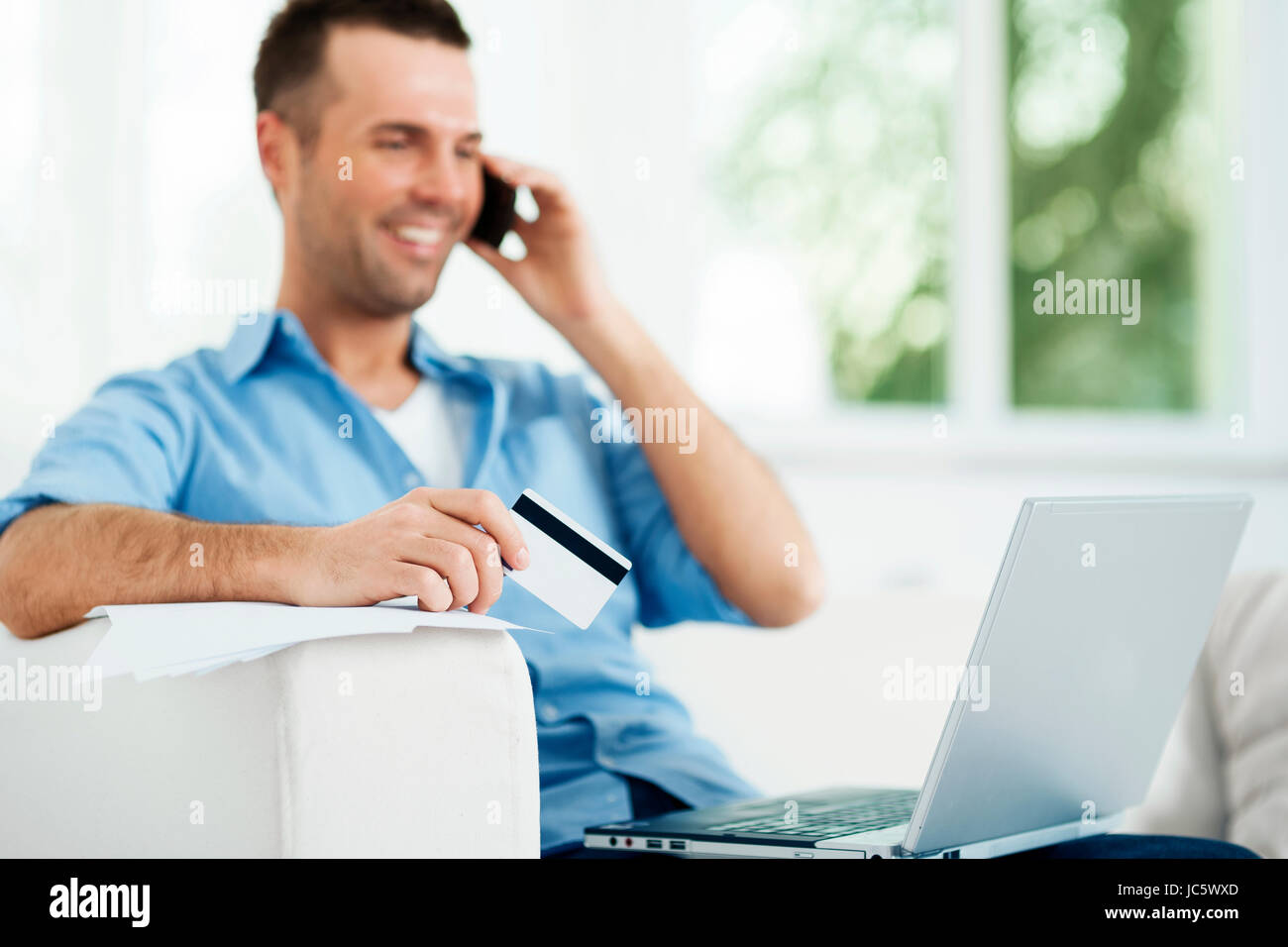 Attractive male paying bills Stock Photo - Alamy