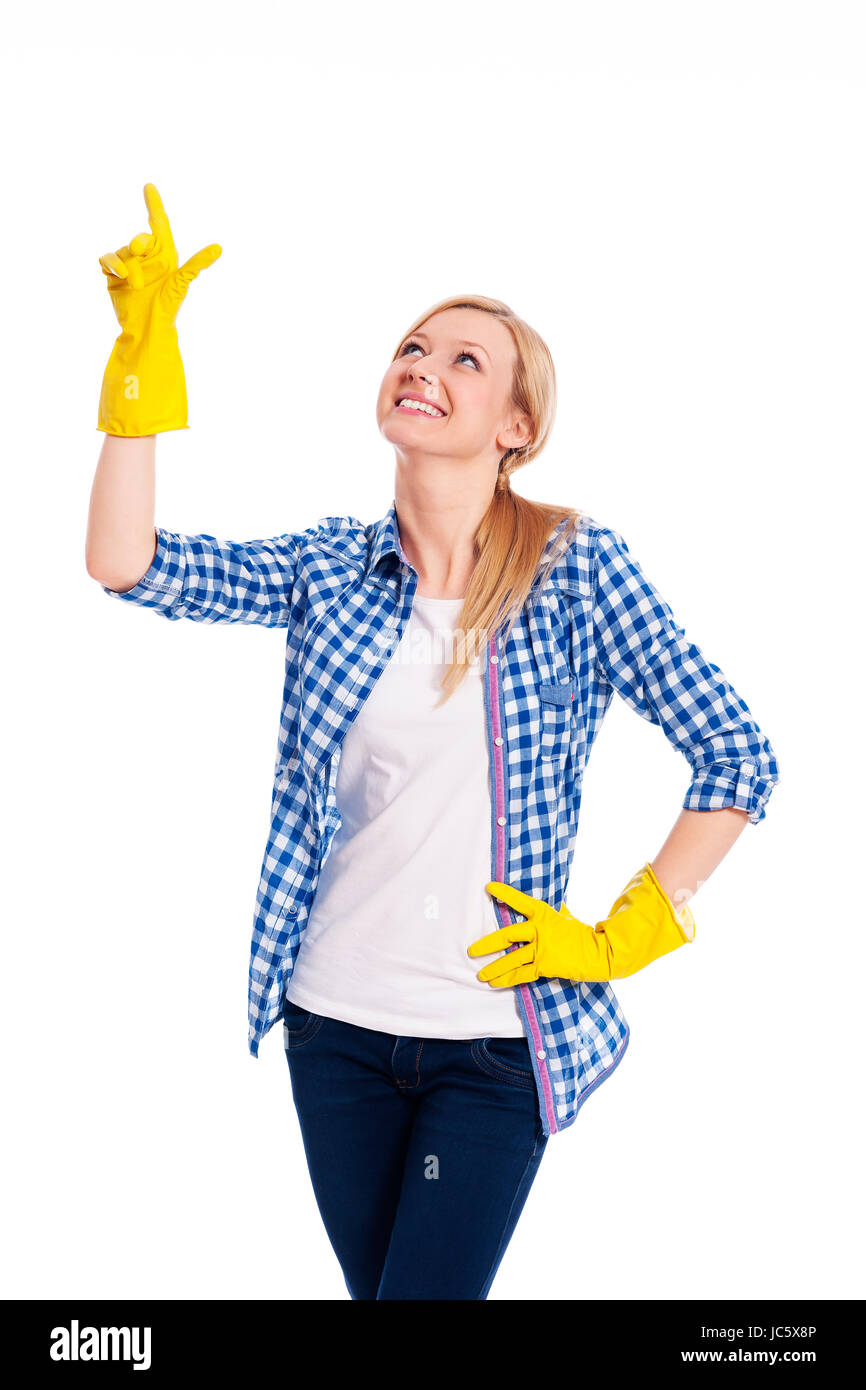 Smiling female cleaner pointing up Stock Photo - Alamy