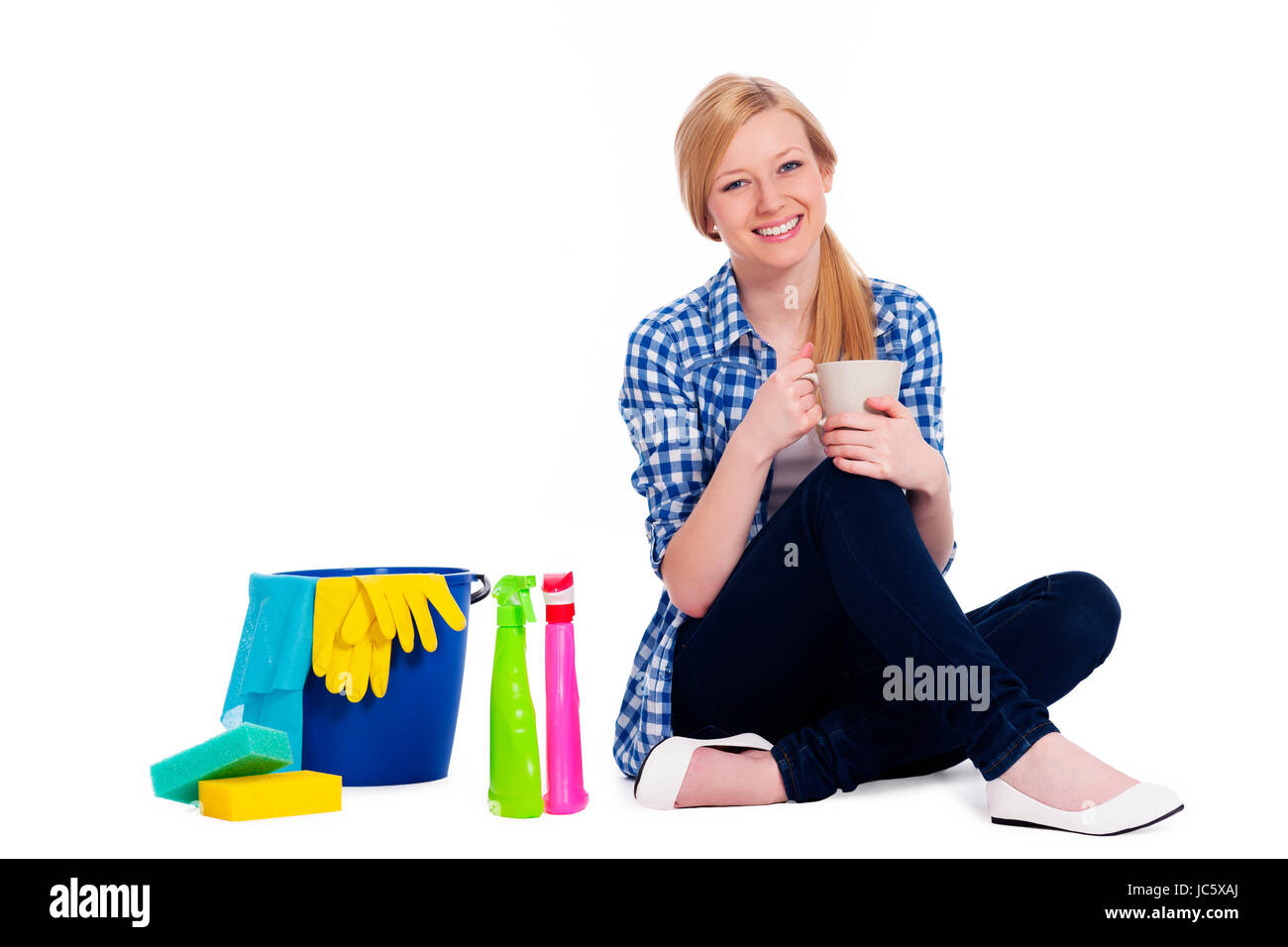 Young woman relaxing after cleaning Stock Photo - Alamy