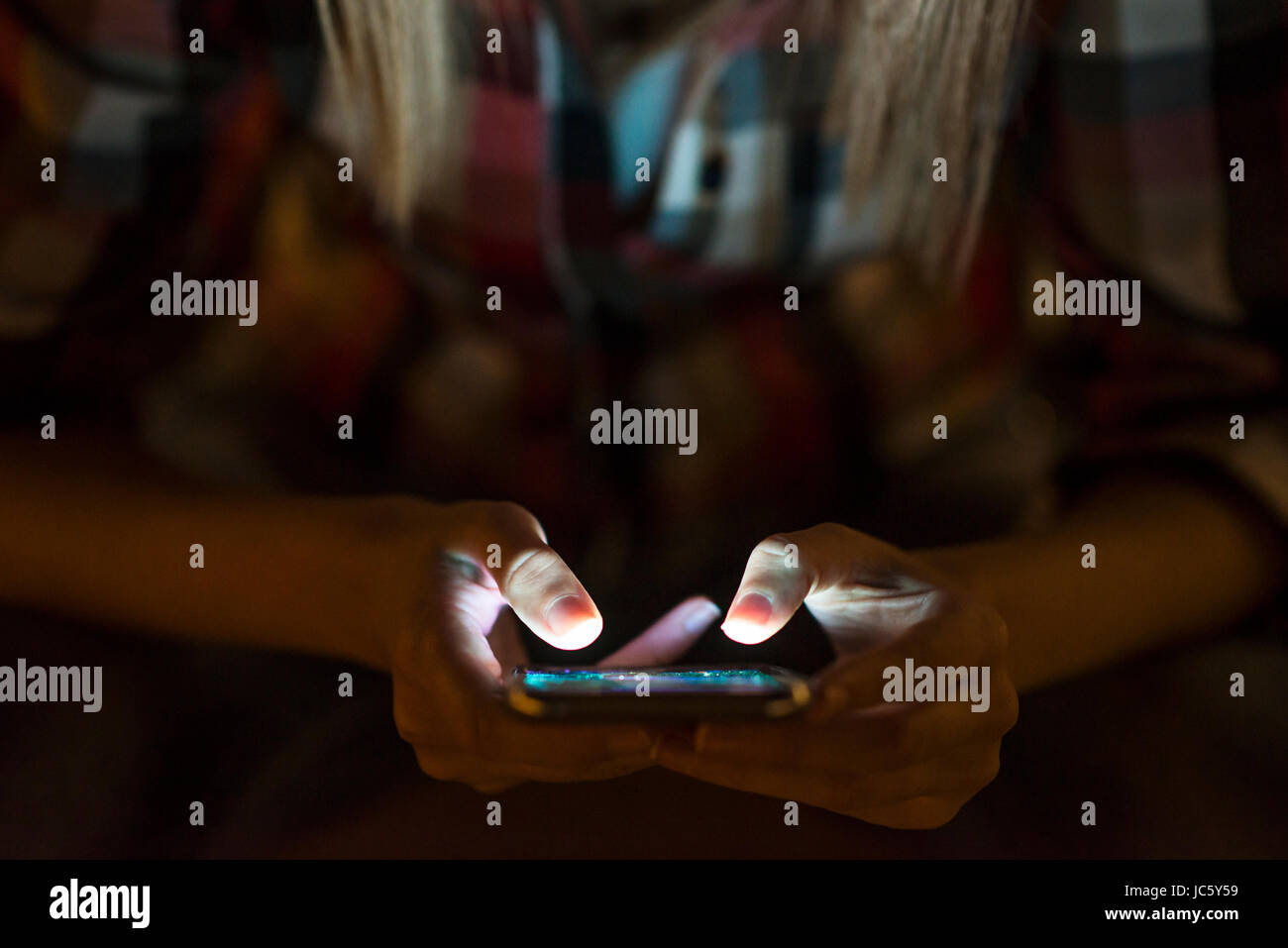 Using smart phone in dark Stock Photo - Alamy