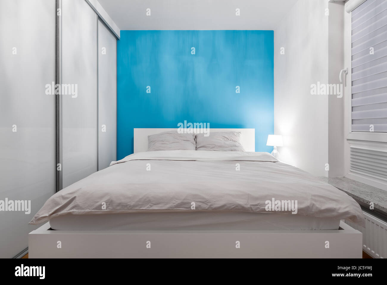 White bedroom with azure wall,closet and double bed Stock Photo - Alamy