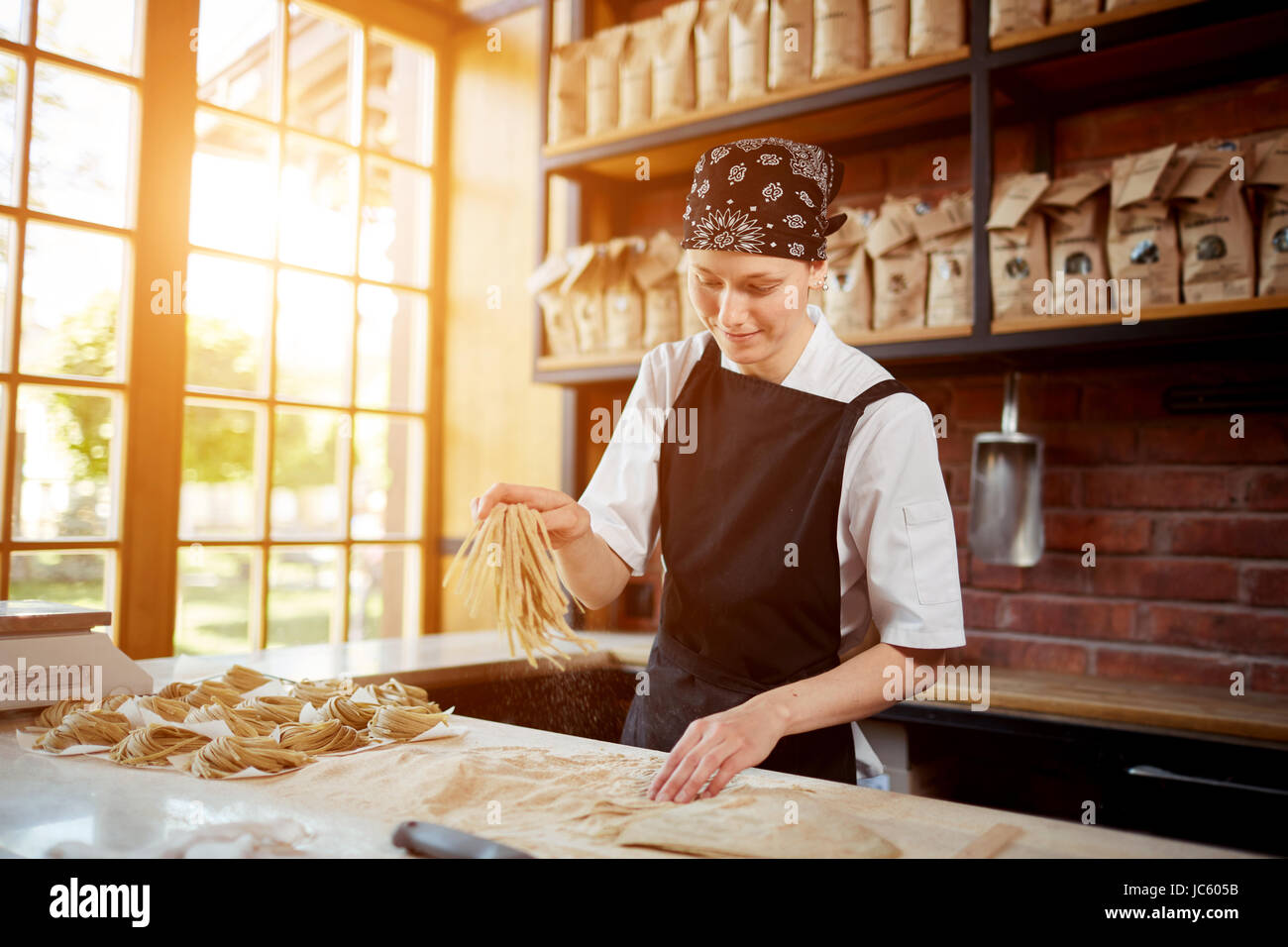 Woman cooking noodles hi-res stock photography and images - Alamy