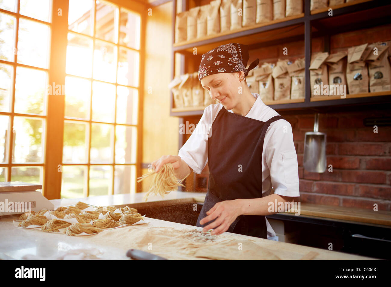 Woman cooking noodles hi-res stock photography and images - Alamy