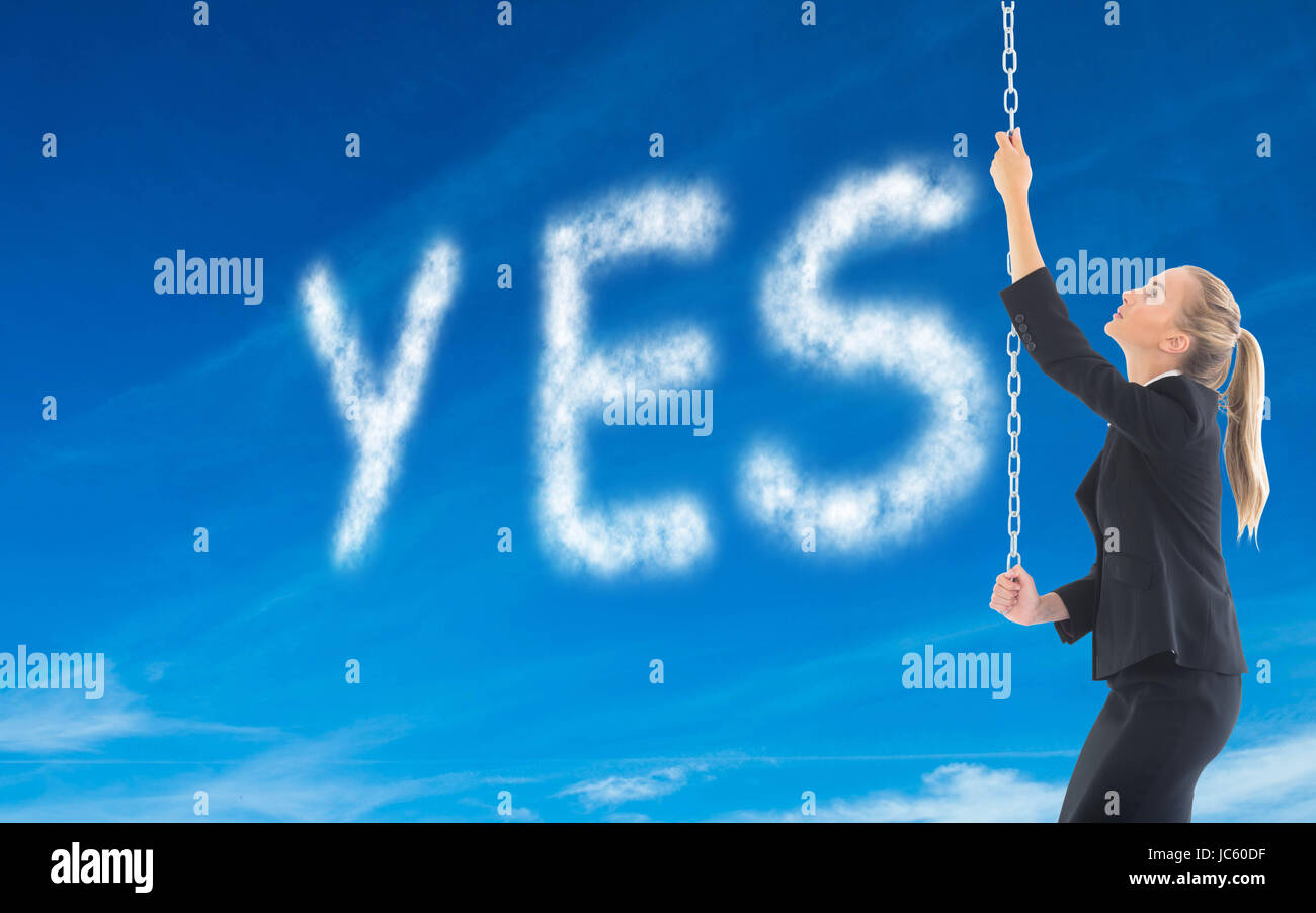 Composite image of blonde businesswoman pulling a chain Stock Photo - Alamy