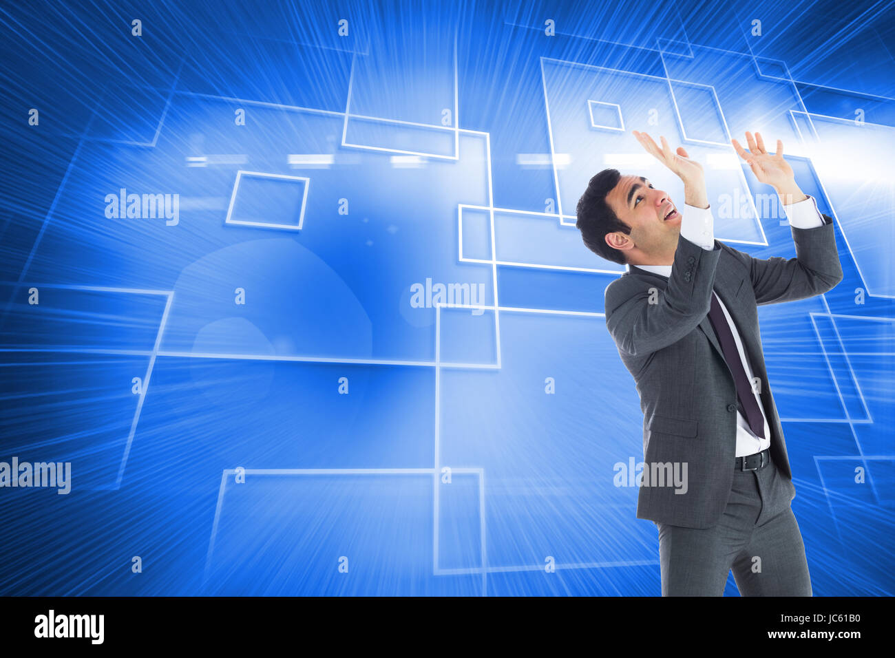 Composite image of scared businessman with arms raised Stock Photo - Alamy
