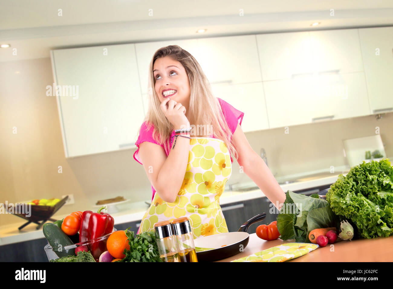Beautiful woman cooking in the kitchen Stock Photo - Alamy