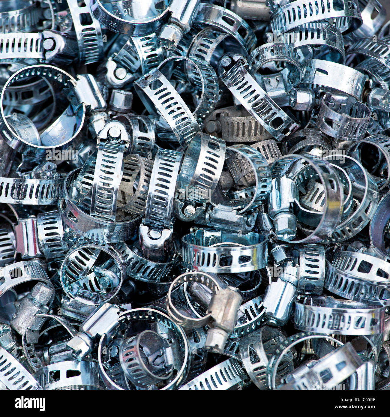 Big pile of bolt band clamps parts Stock Photo - Alamy