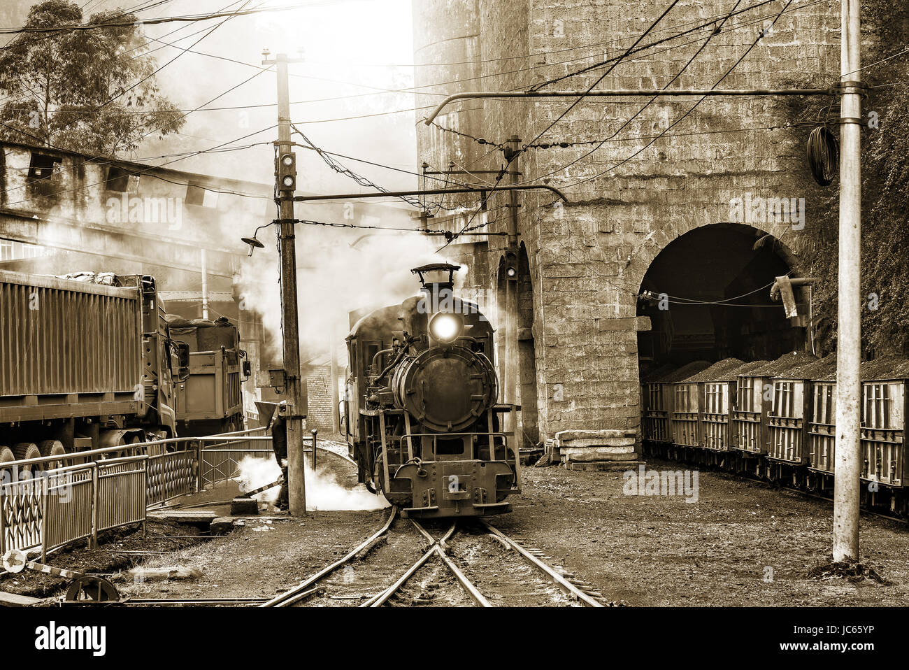 Steam narrow-gauge locomotive stands by the coal loading point. Sichuan ...