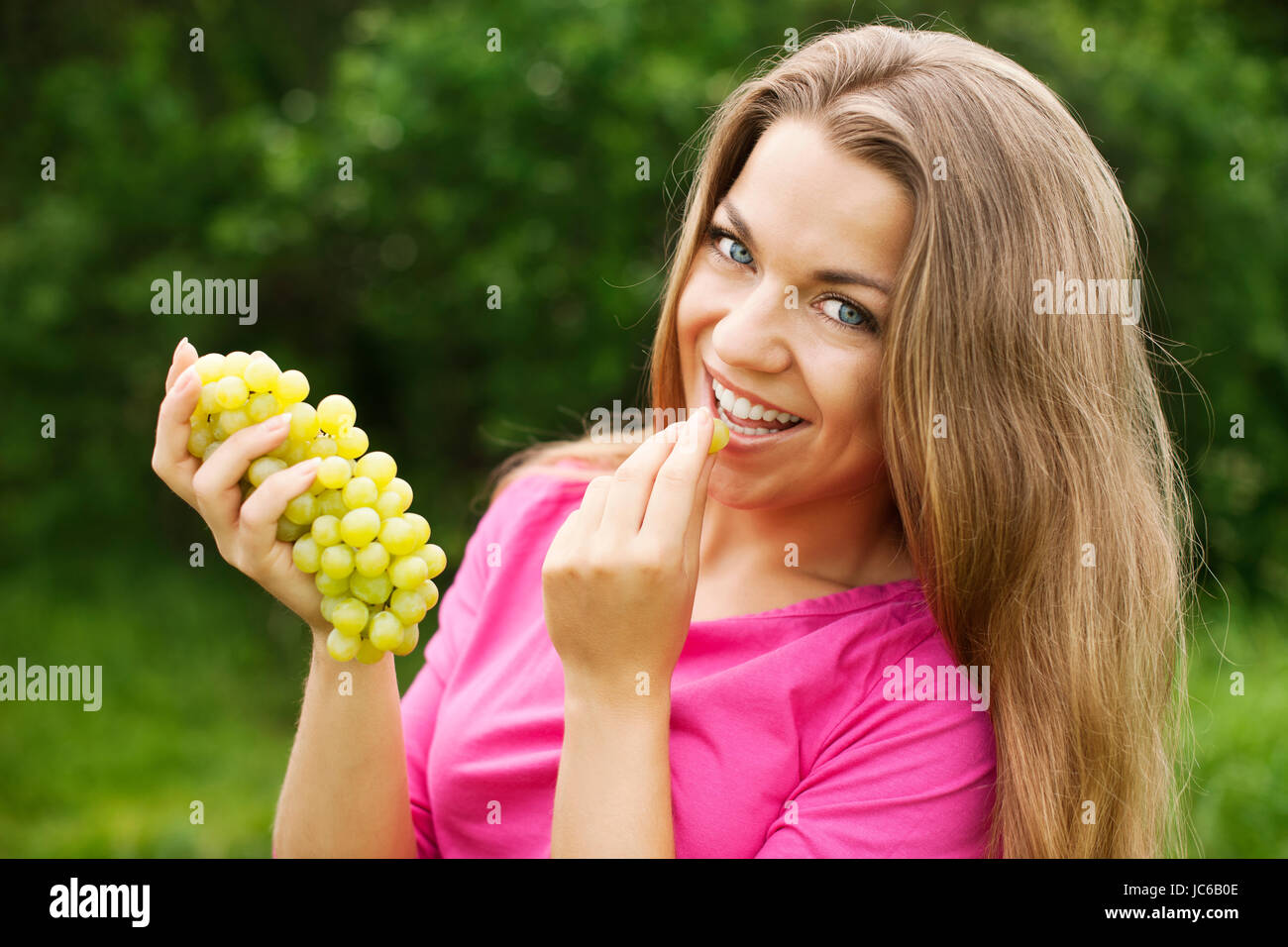 Young woman with grapes Stock Photo - Alamy