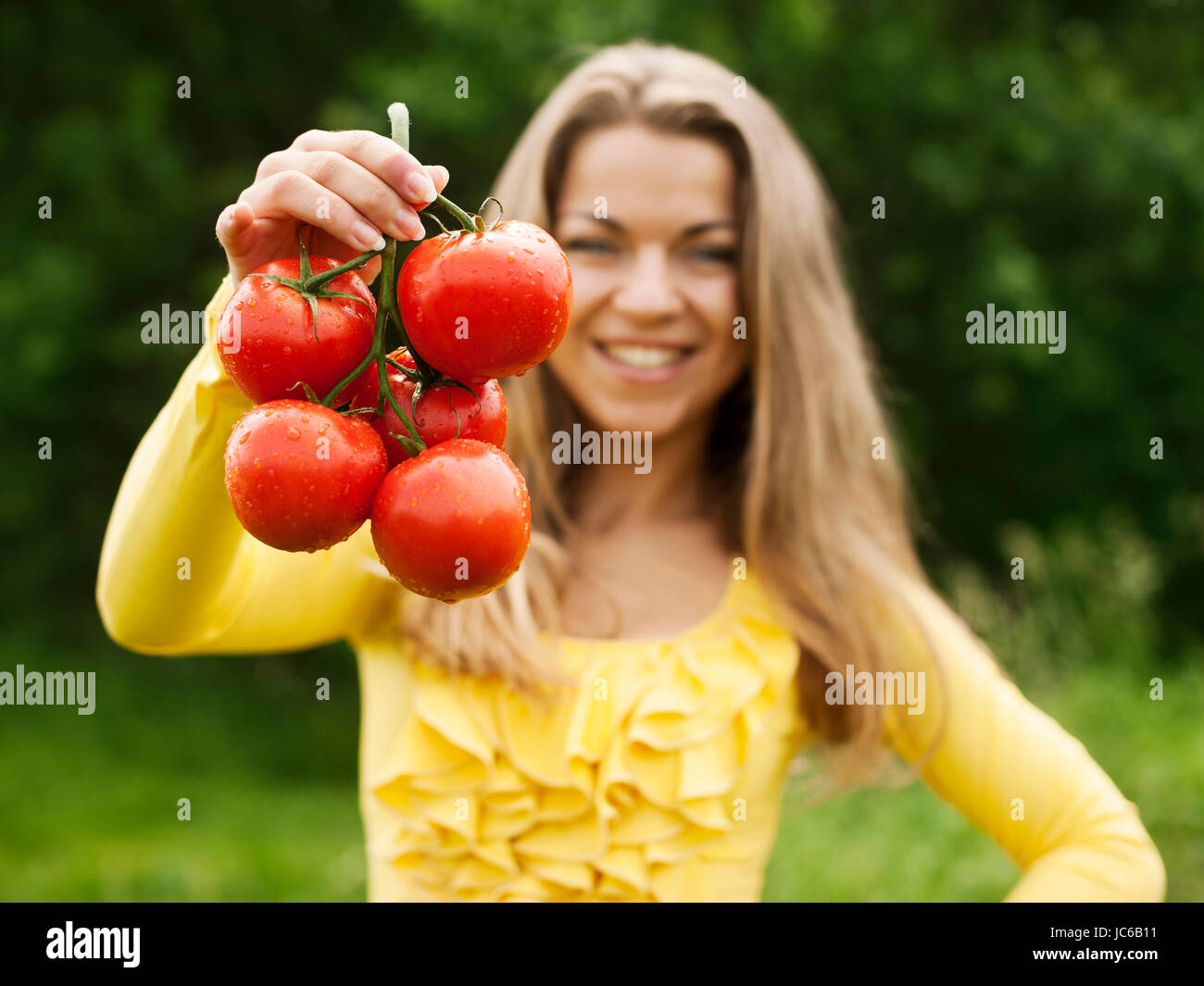 Woman with tomatoes Stock Photo - Alamy