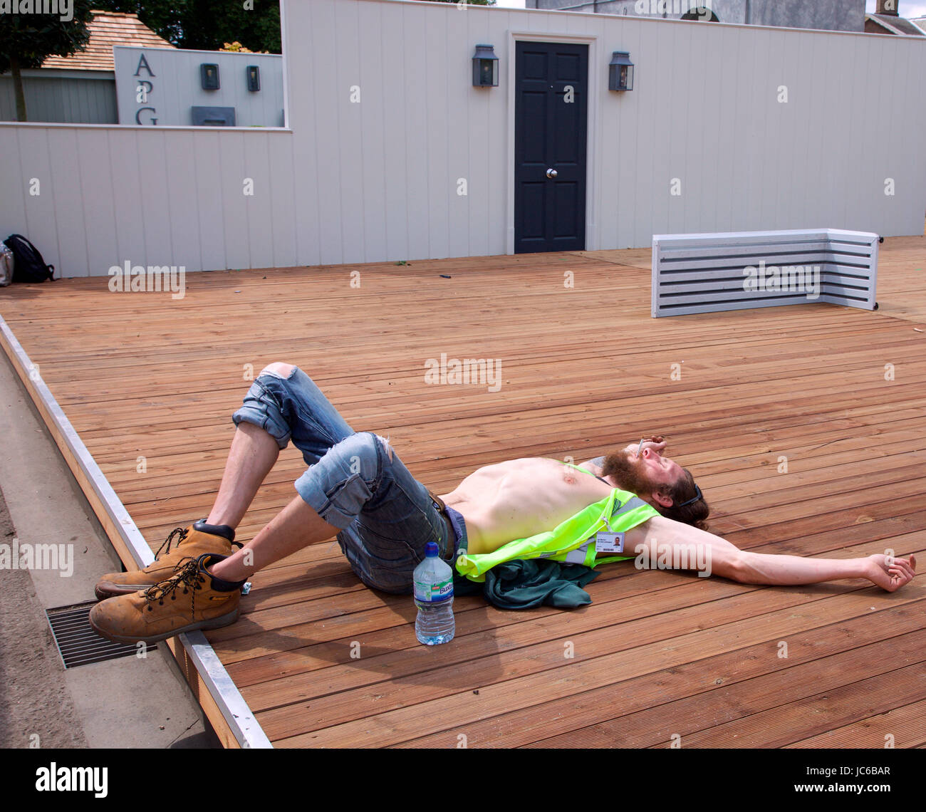 Exhausted landscaper at the Chelsea Flower Show, probably after an all ...
