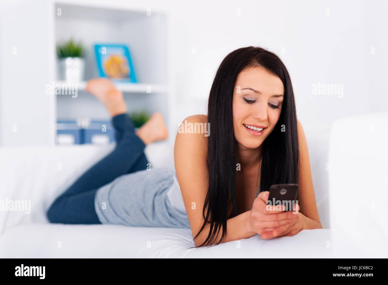 Beautiful woman reading a text with mobile phone Stock Photo - Alamy