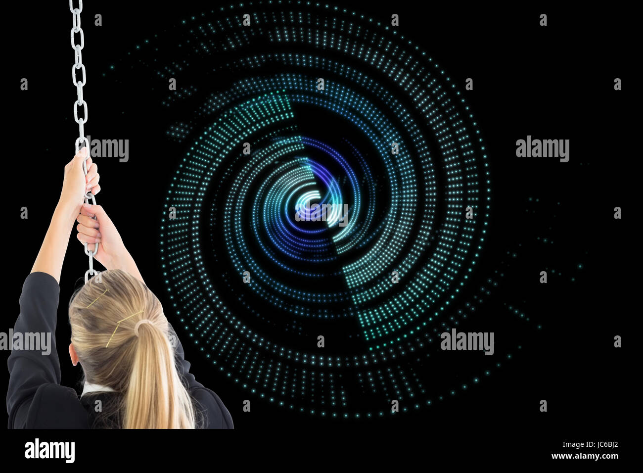 Composite image of blonde businesswoman pulling a chain Stock Photo - Alamy