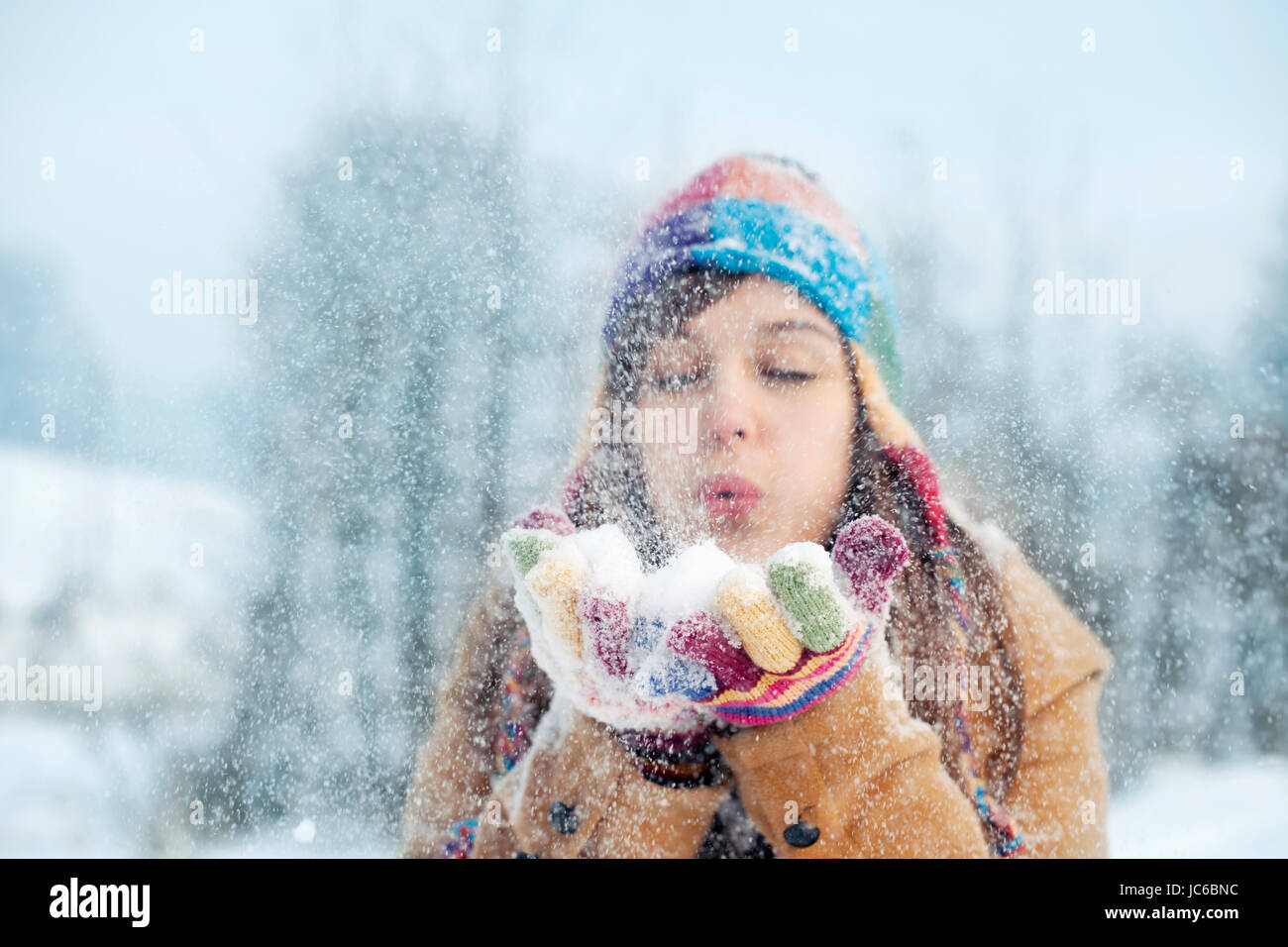 Young woman blowing snow to away Stock Photo - Alamy