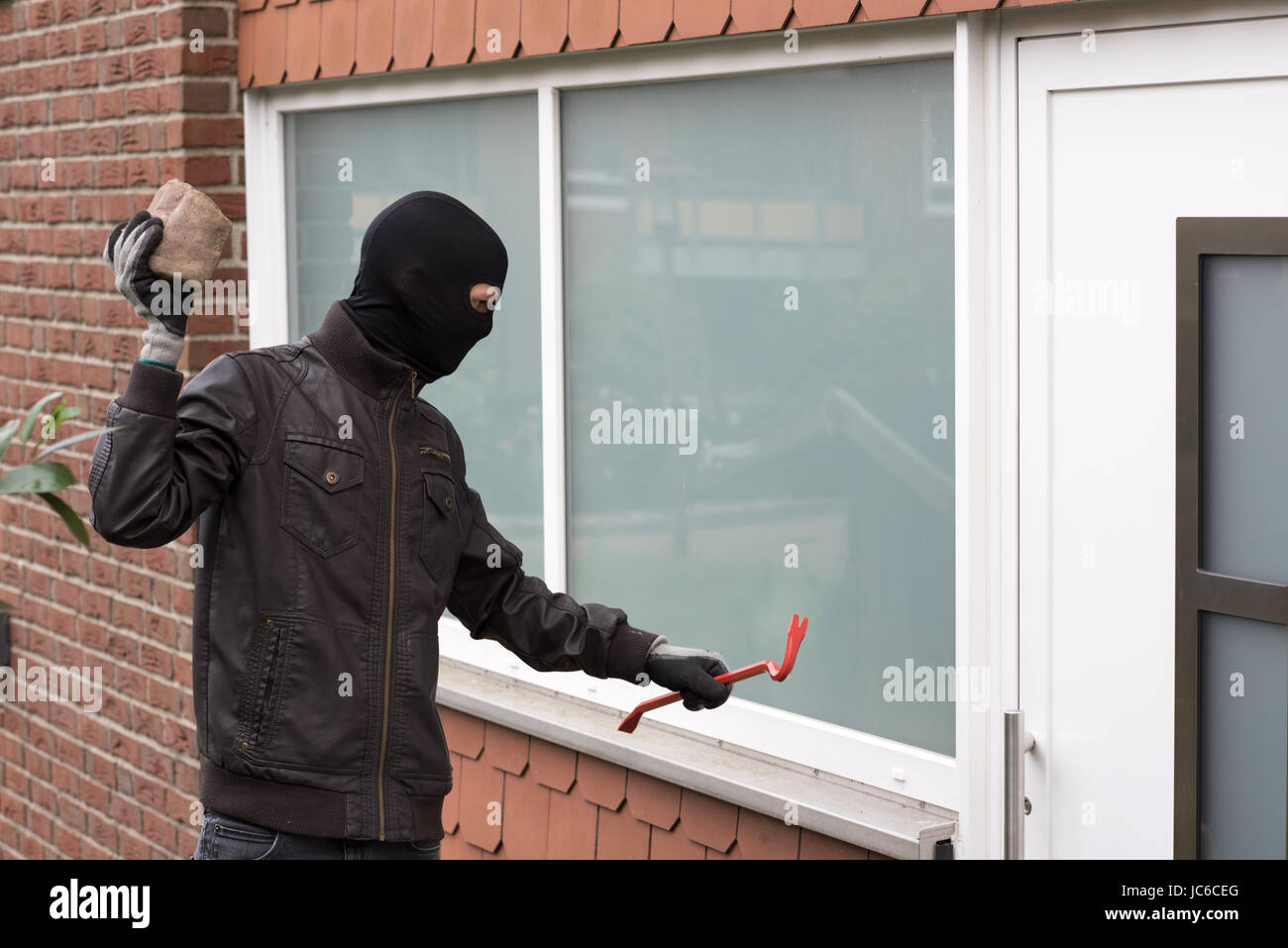 burglar with crowbar Stock Photo - Alamy