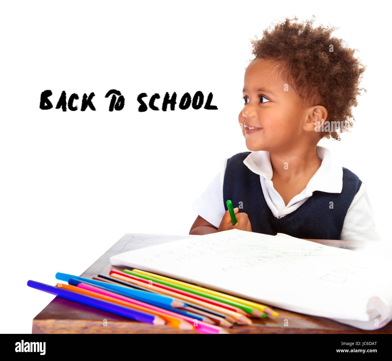 Portrait of little American boy drawing with colourful pencils ...