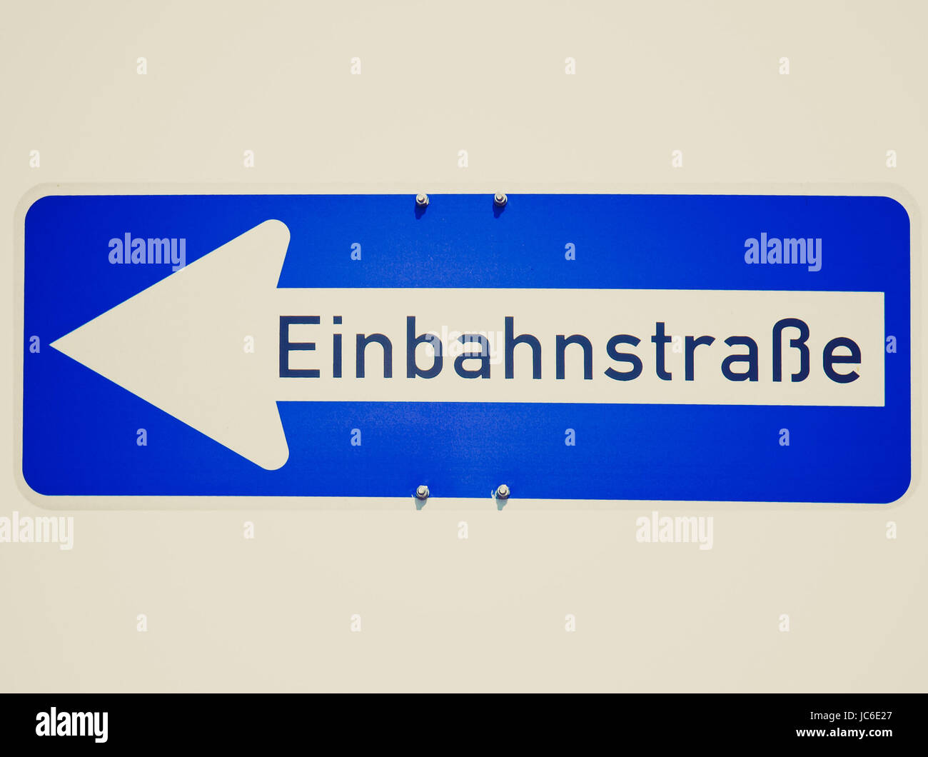 Vintage retro looking One way traffic sign in German (Einbahnstrasse ...