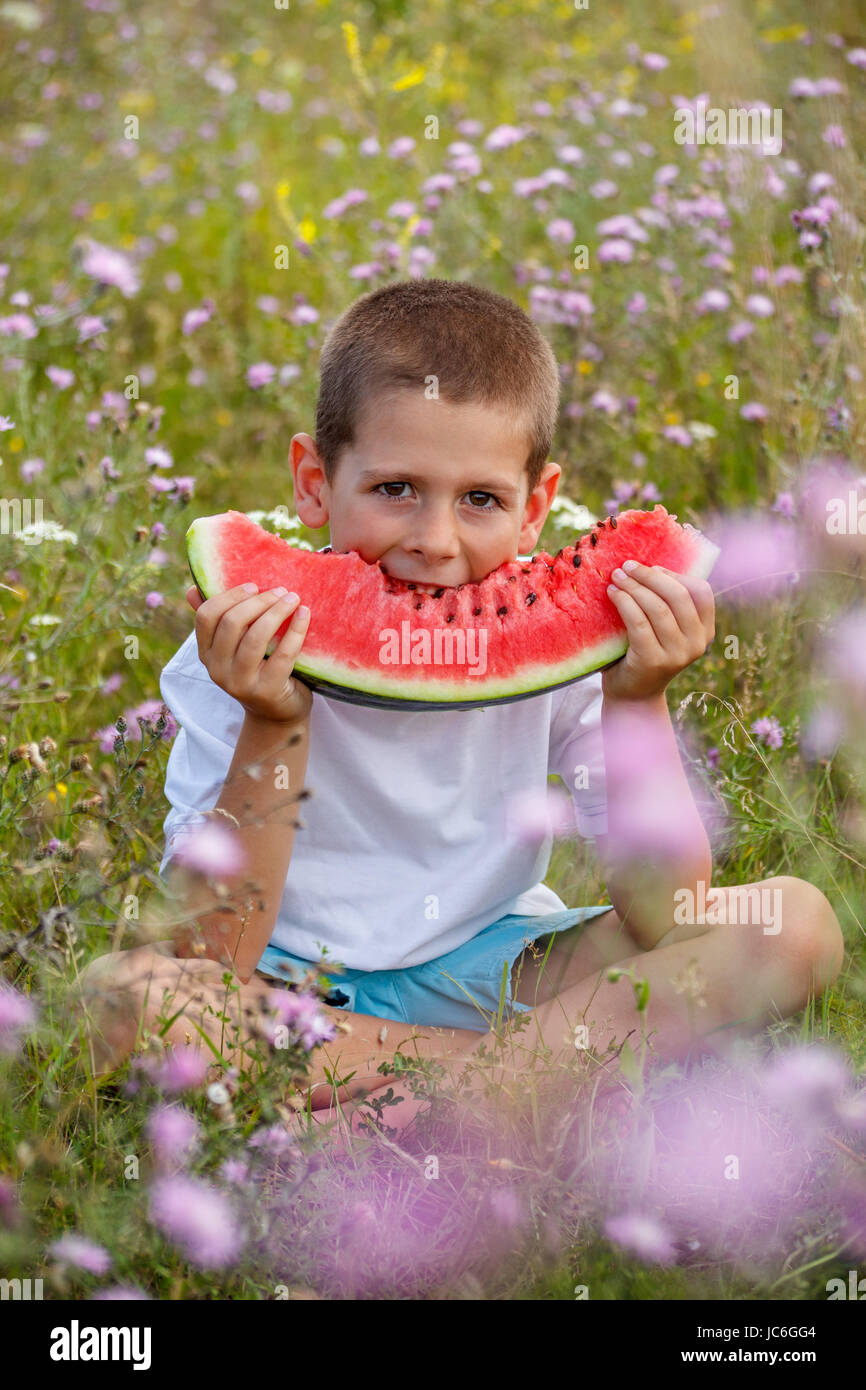 Happy kid with big red slice of watermelon Stock Photo - Alamy