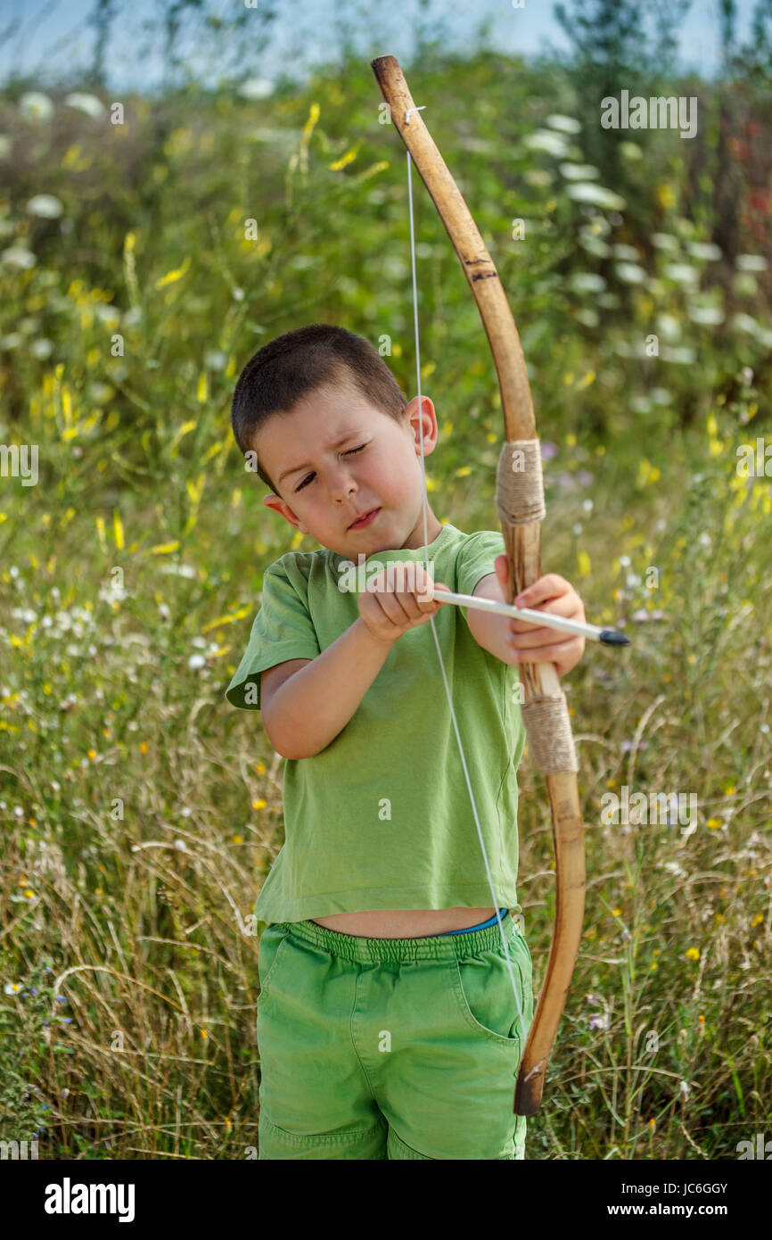 Boy shoots a bow at a target, in the open air Stock Photo - Alamy