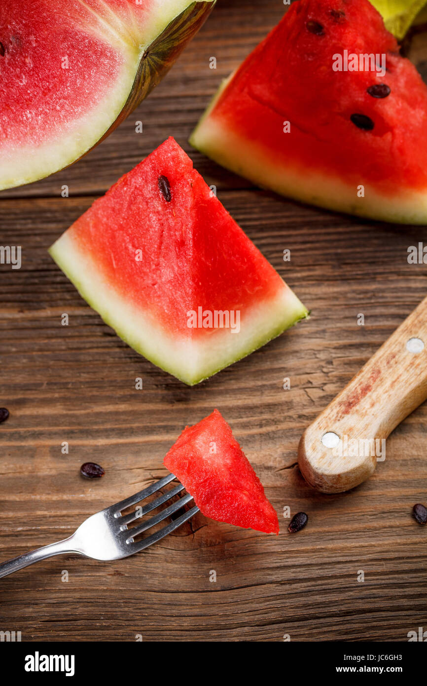 Slices of watermelon on fork Stock Photo - Alamy
