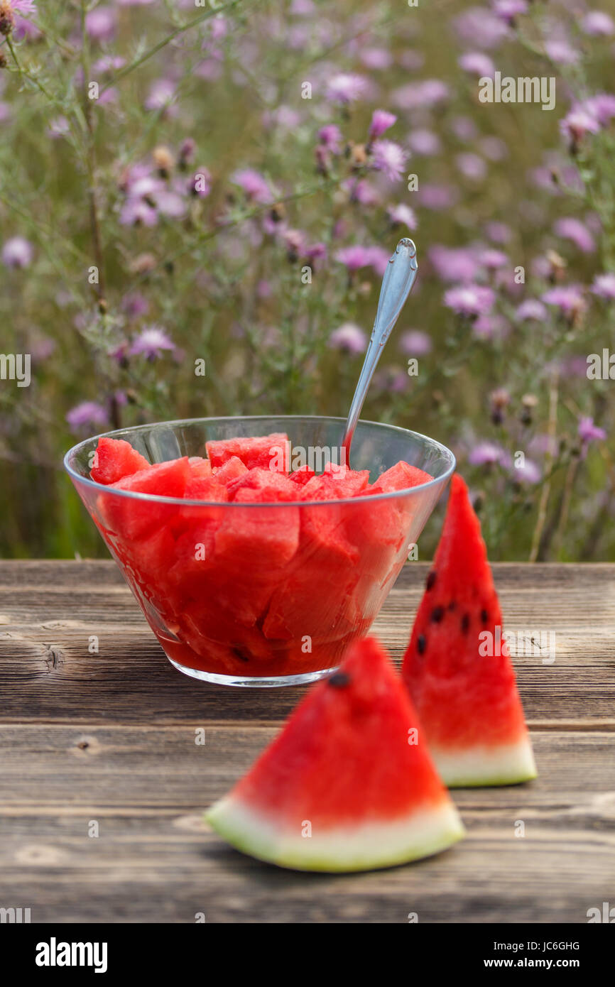 Ripe watermelons on wooden table on nature background Stock Photo - Alamy