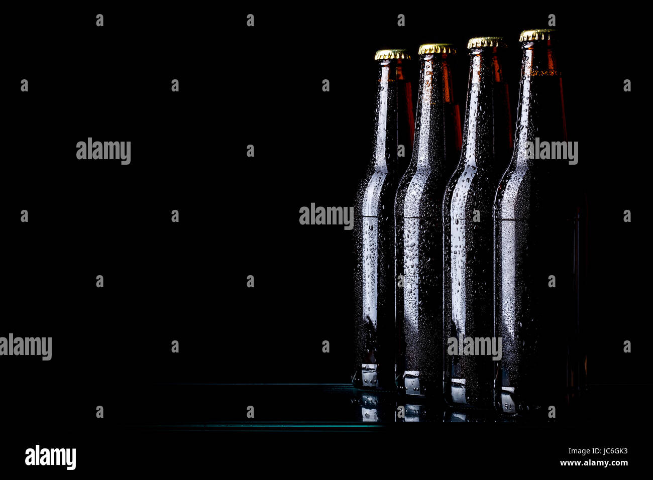 Beer bottles on black background Stock Photo - Alamy