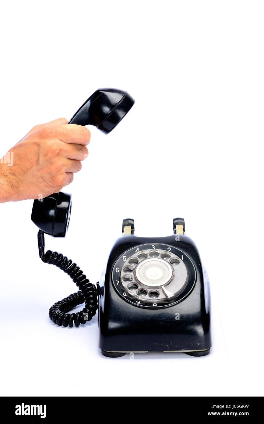 Hand holding an old black telephone isolated on white background Stock ...