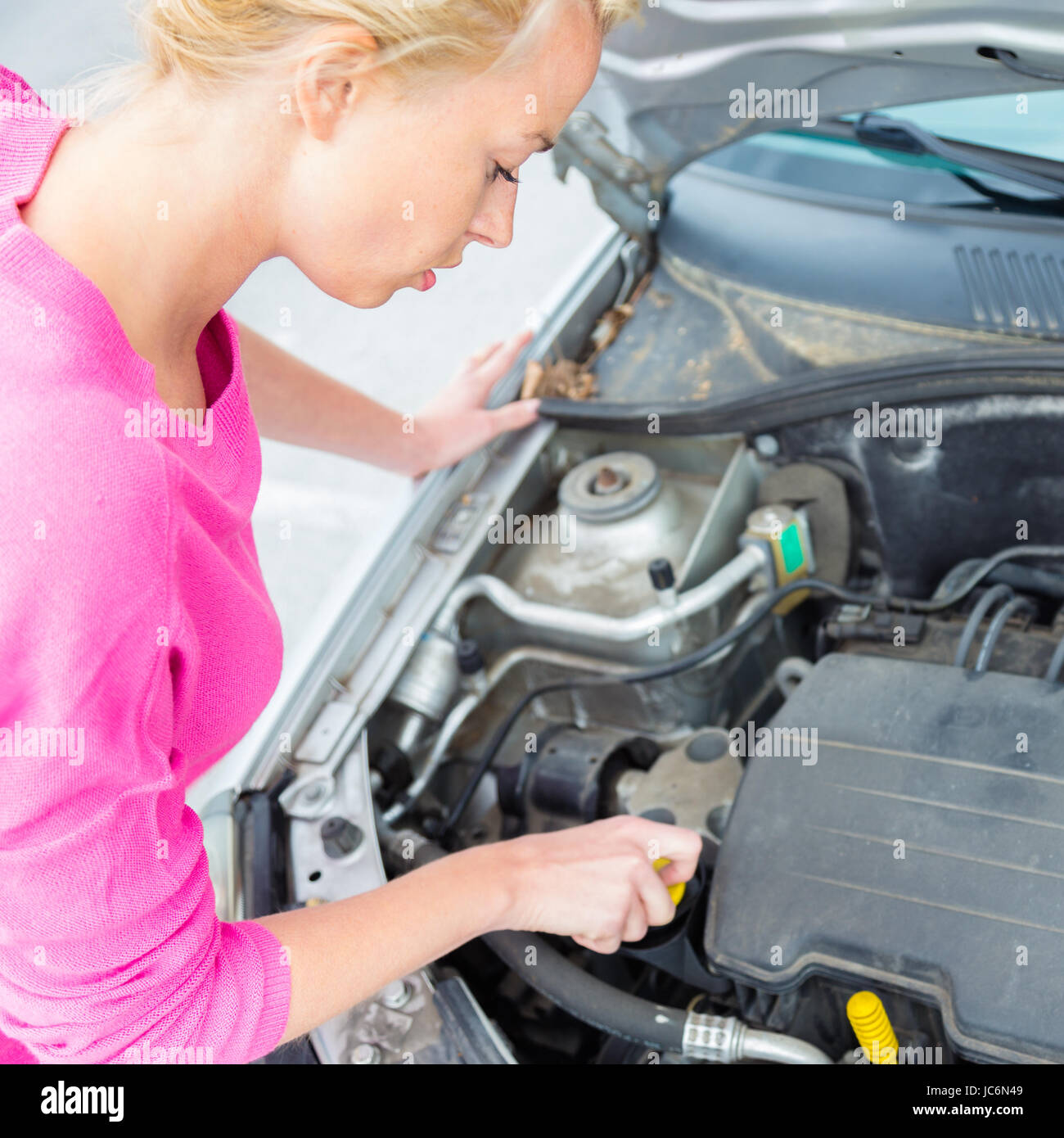 Self-sufficient confident modern young woman checking level of the ...