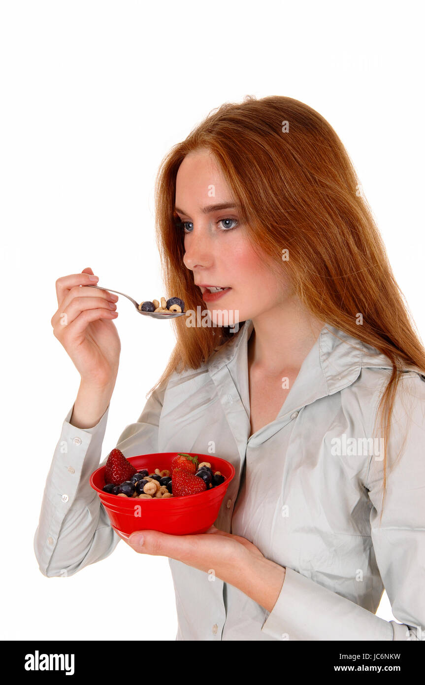 A closeup picture of a young woman holding a bowl with serial and ...