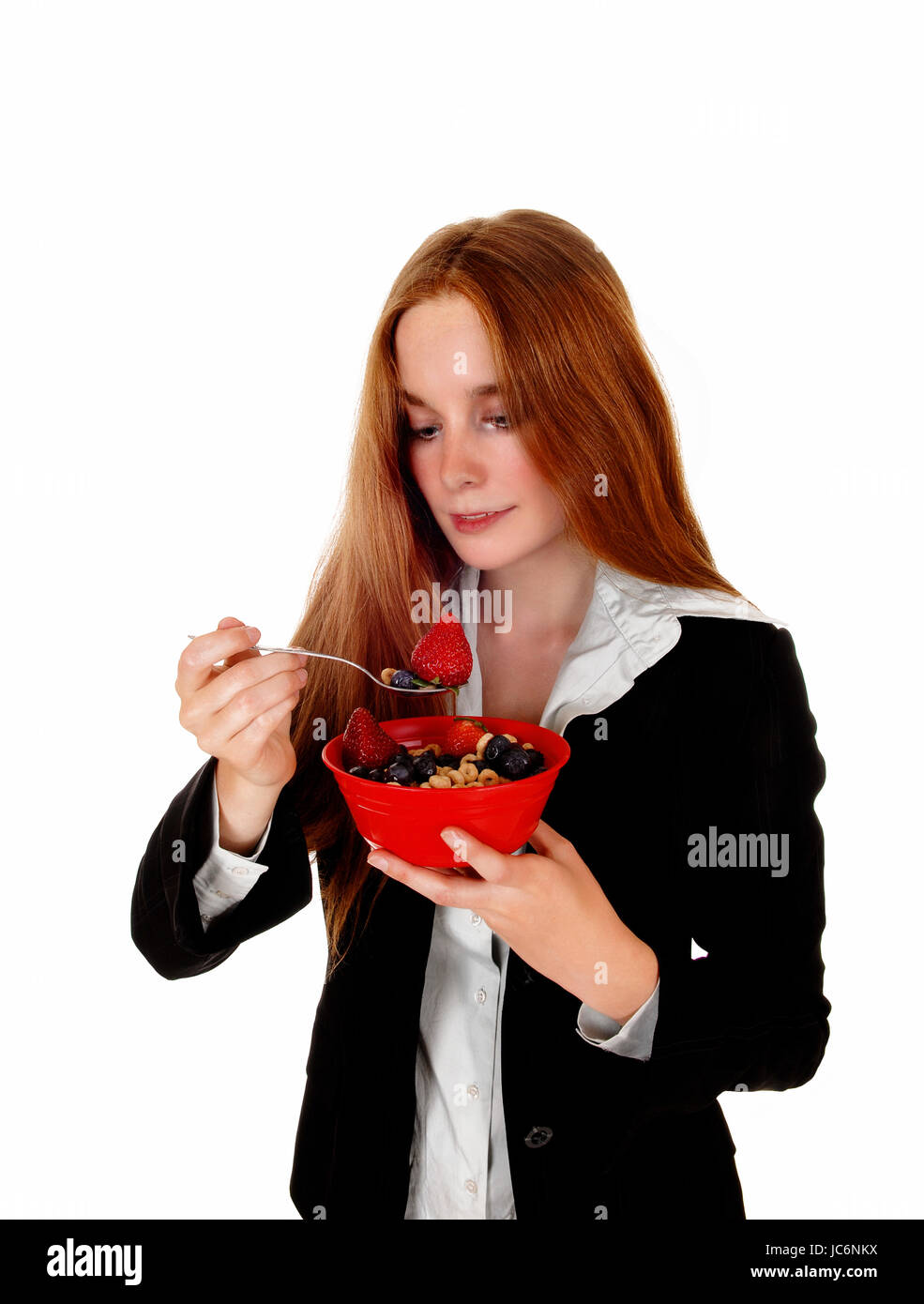 A closeup picture of a young woman holding a bowl with serial and ...