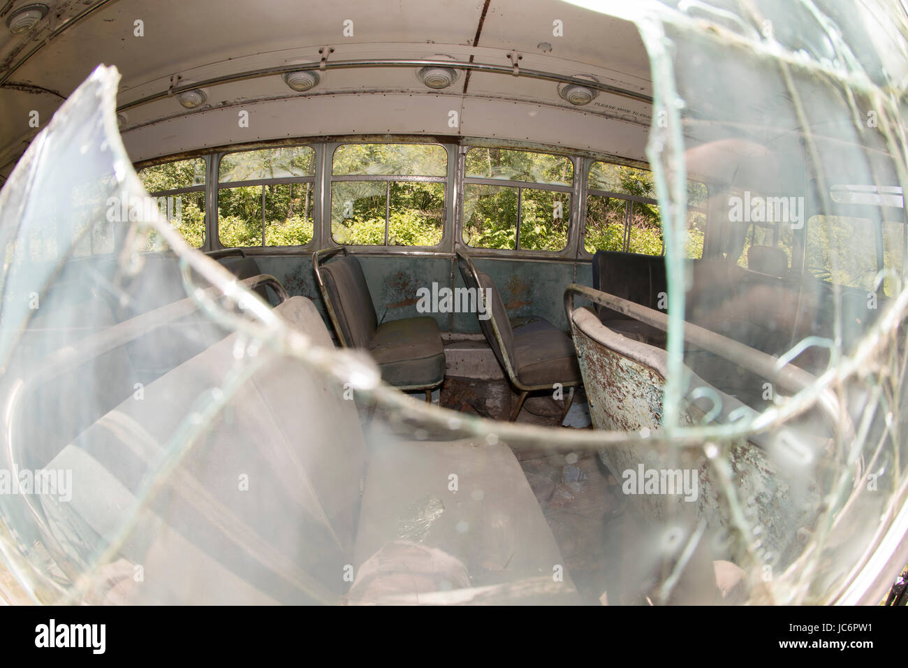 Old damaged public bus through broken shards of safety glass Stock ...