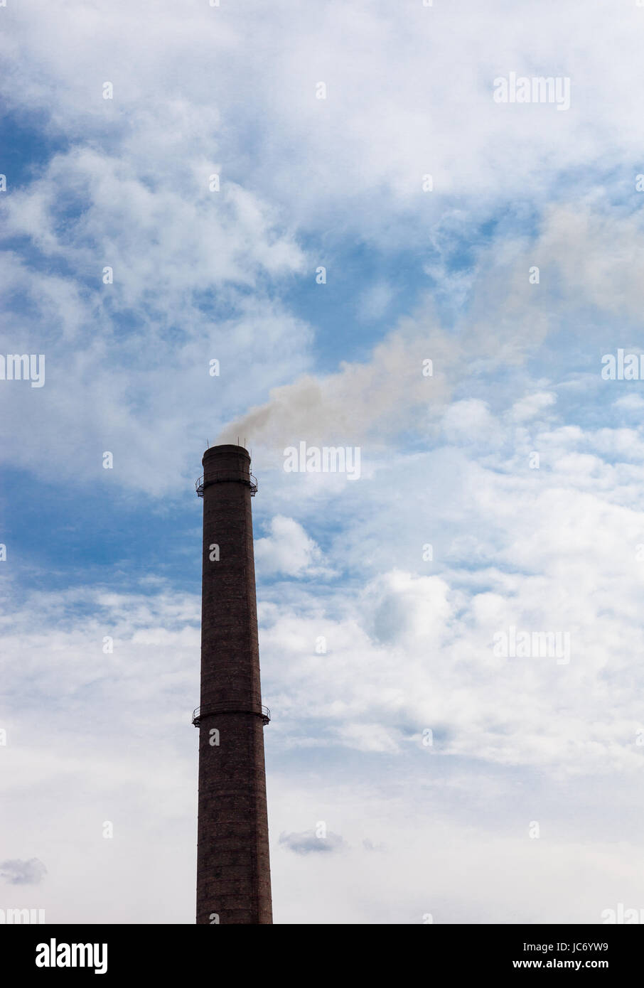 Smoke stack of the industrial plant against the cloudy sky Stock Photo ...