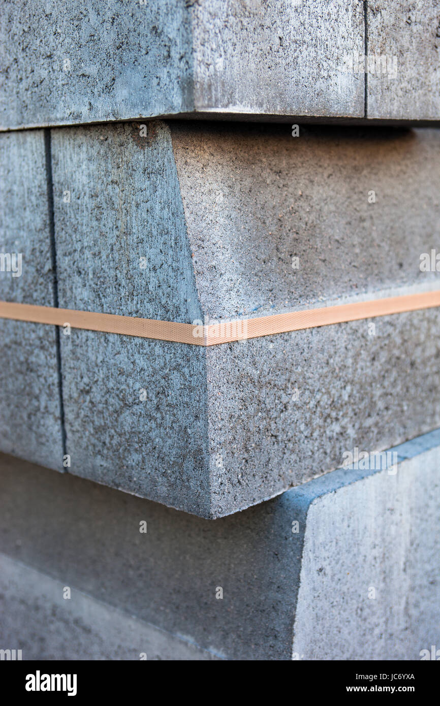 Stack of new concrete blocks tied-up with plastic stripe Stock Photo ...