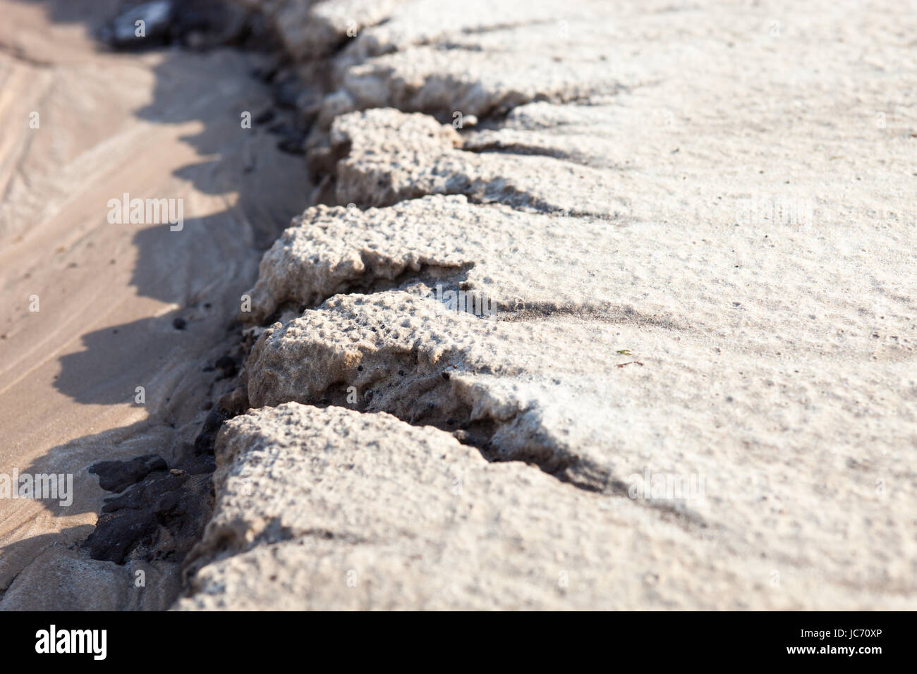Sand surface after the rain with the relief formed by water currents ...