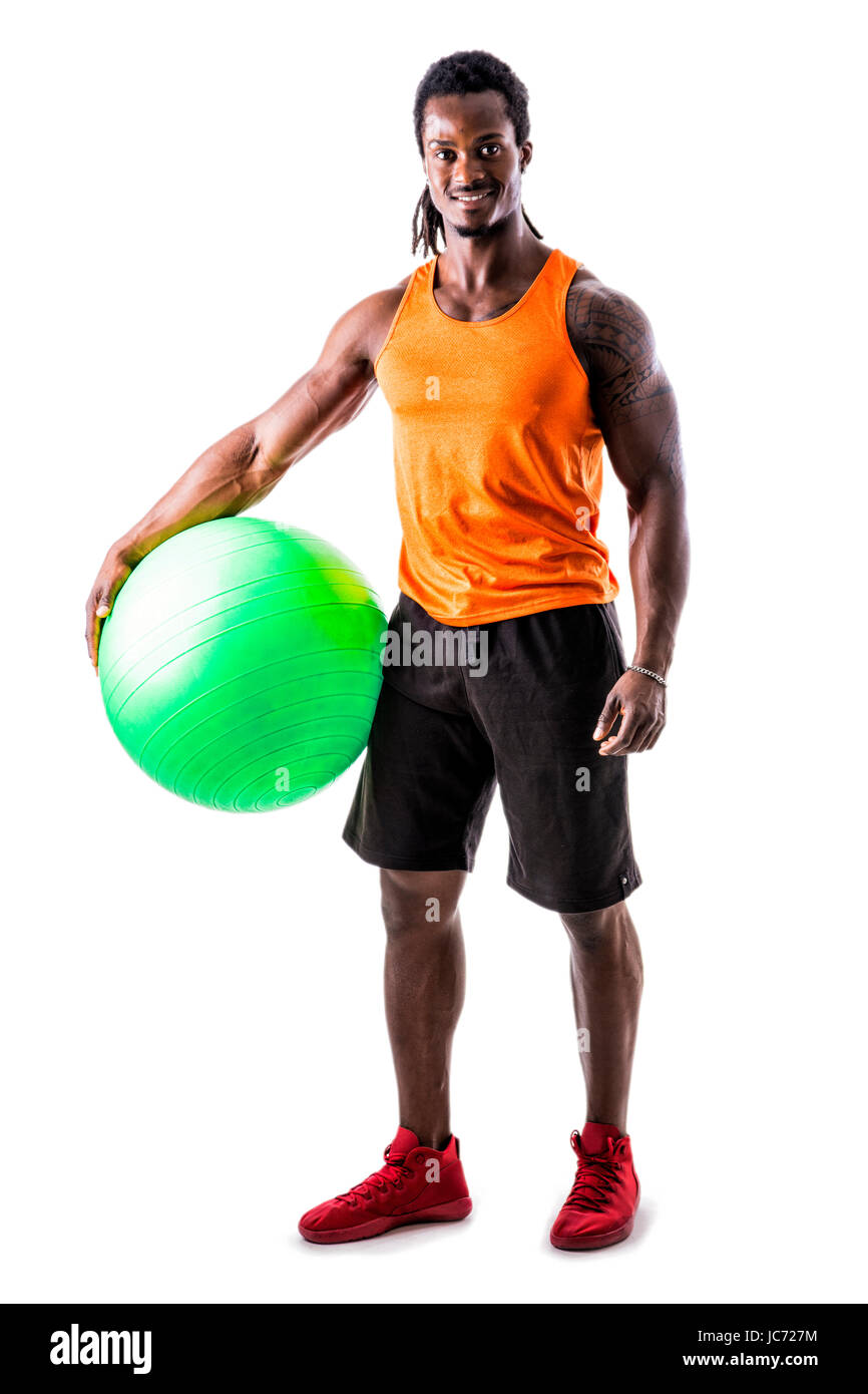 Muscular man holding inflatable fitness ball, looking at camera ...