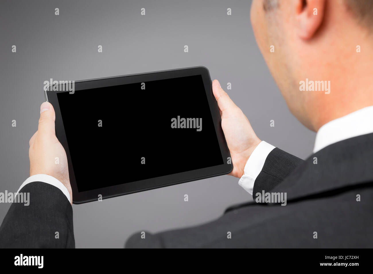 An image of a handsome business man reading his tablet pc Stock Photo ...