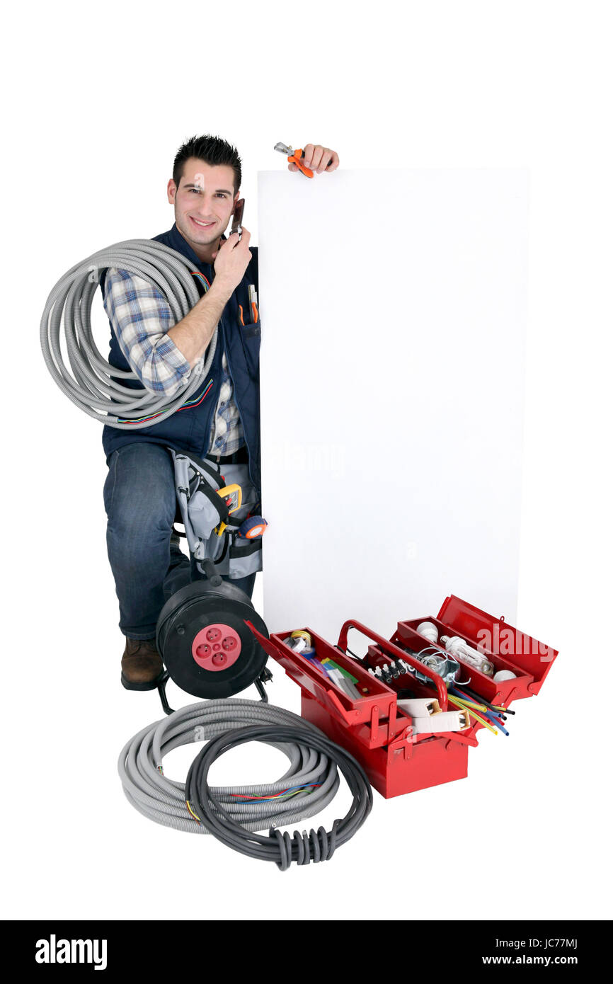 Tradesman posing with a blank sign and his tools Stock Photo - Alamy