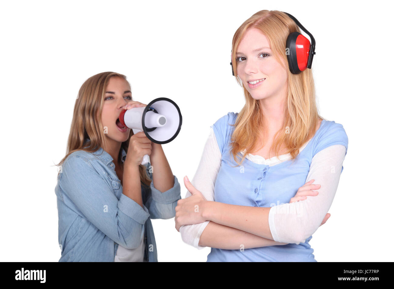 girl shouting in loudspeaker at female workmate Stock Photo - Alamy