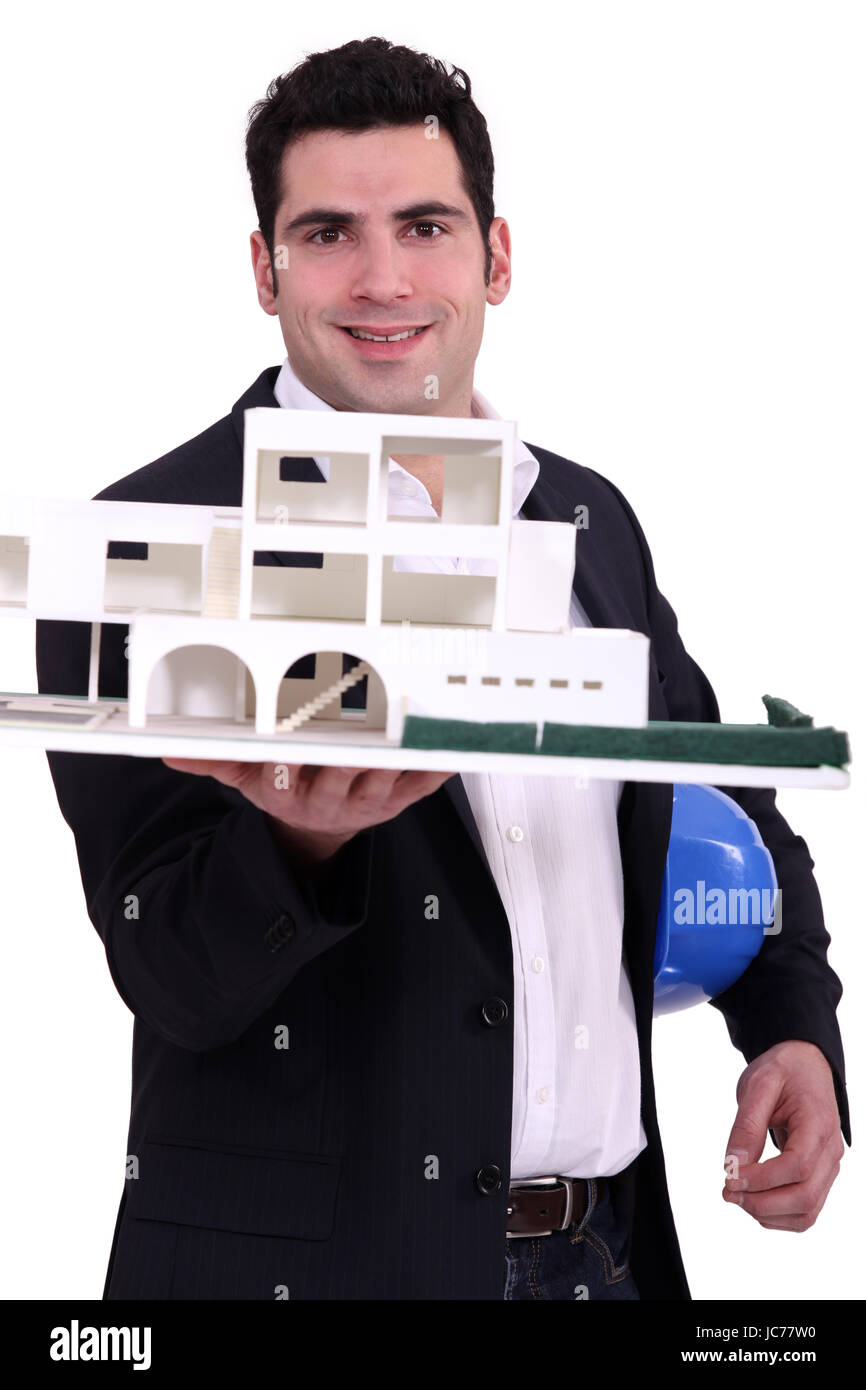 Architect holding up a building model Stock Photo - Alamy