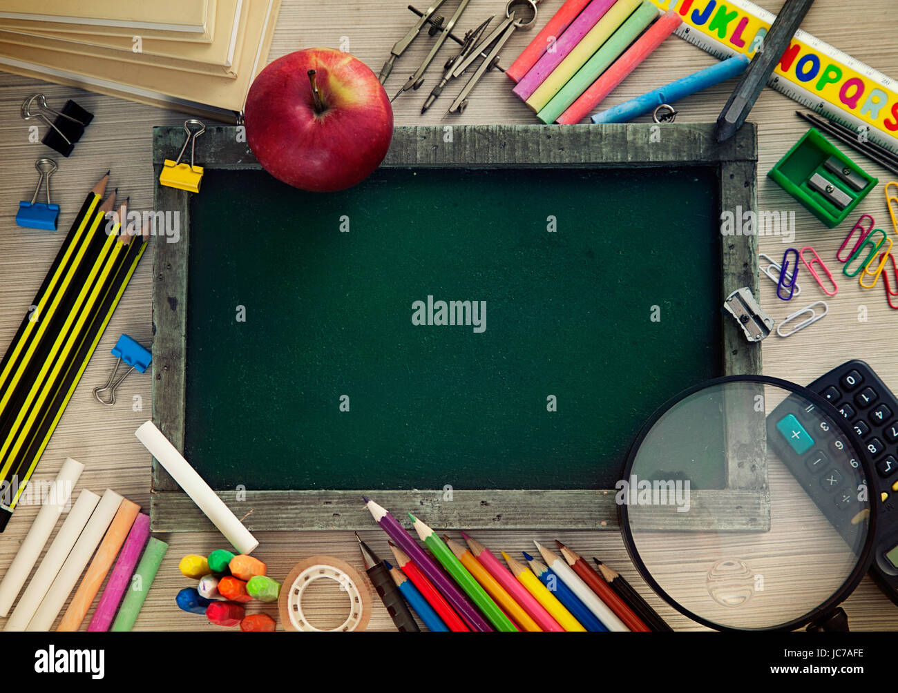 School objects for students. Chalkboard, pencils, crayons and apple ...