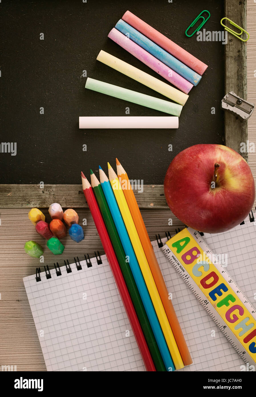 School objects for students. Chalkboard, pencils, crayons and apple ...