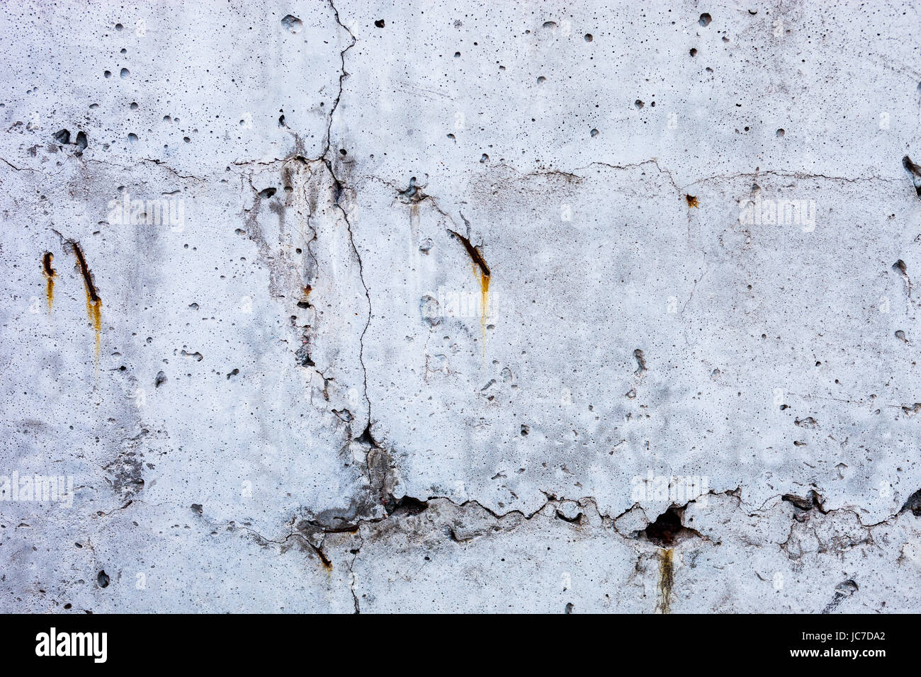 Grey concrete surface with the hardened traces of the shuttering moulds ...